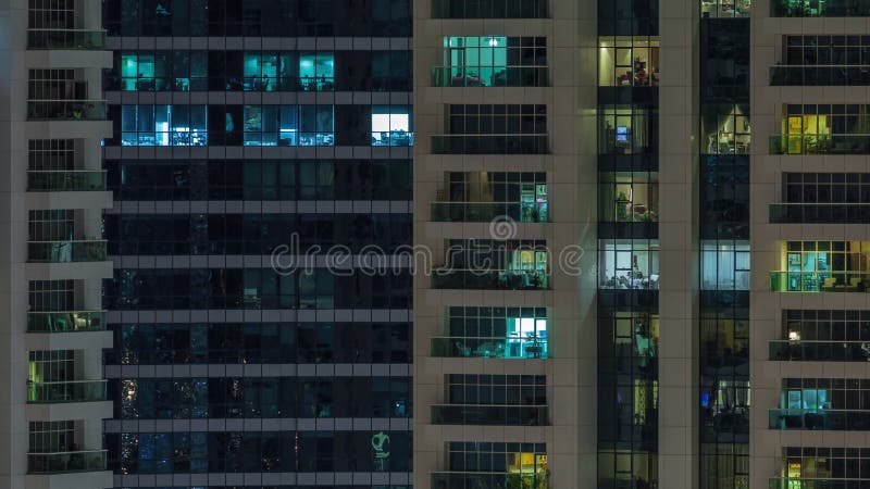 Rows of Glowing Windows with People in Apartment Building at Night ...