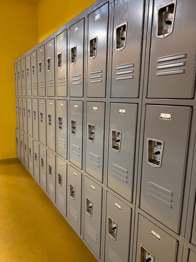 Rows of Gray School Lockers Lined Up Against a Yellow Wall Stock Photo ...