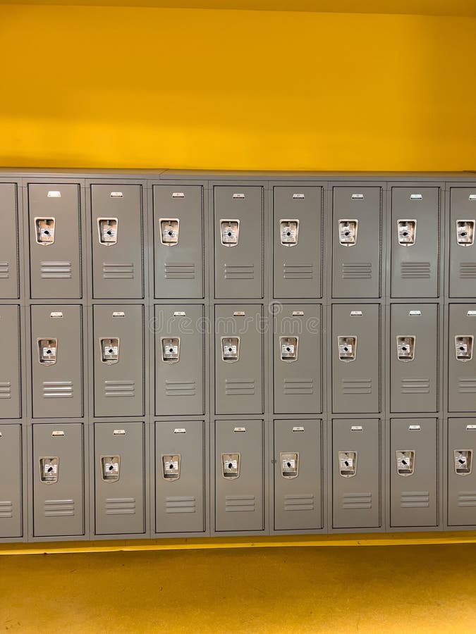 Rows of Gray School Lockers Lined Up Against a Yellow Wall Stock Photo ...