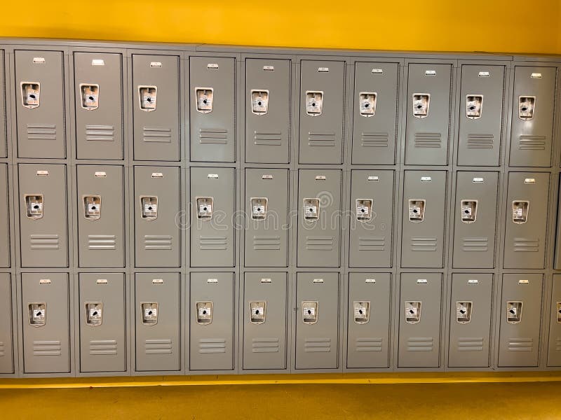 Rows of Gray School Lockers Lined Up Against a Yellow Wall Stock Photo ...