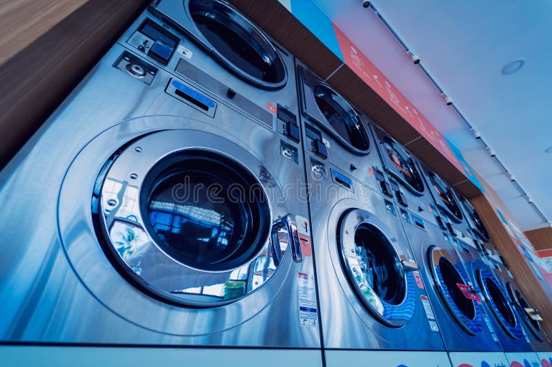 Rows of Industrial Laundry Machines in the Large Laundromat. Stock ...