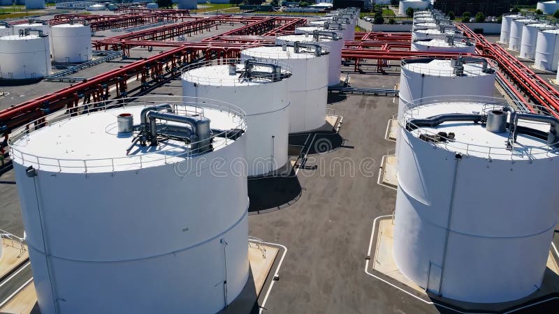 Rows of Large White Cylindrical Fuel Storage Tanks at a Refinery or ...
