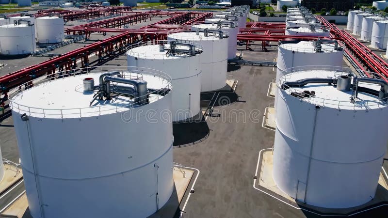 Rows of Large White Cylindrical Fuel Storage Tanks at a Refinery or ...