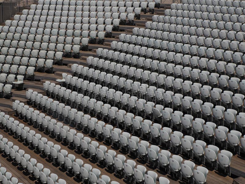 Rows of Numbered Empty Plastic Seats at an Open-air Amphitheater. Many ...