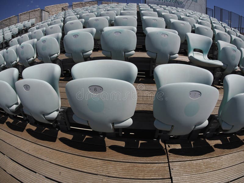 Rows of Numbered Empty Plastic Seats at an Open-air Amphitheater. Many ...