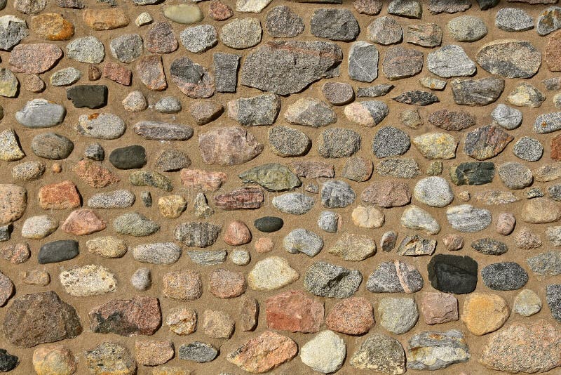 Rows of Rocks Set in Concrete Wall Stock Image - Image of pattern ...