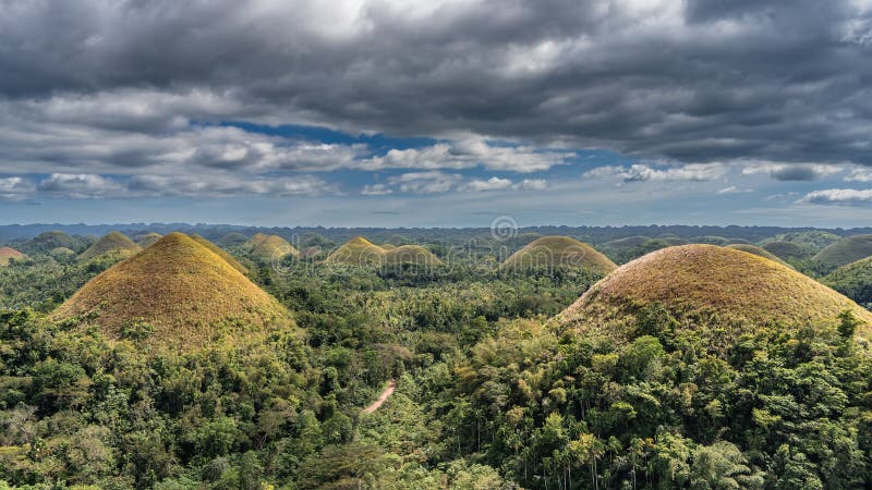Rows of Rounded Conical Hills Covered with Brownish Grass Stretch To ...