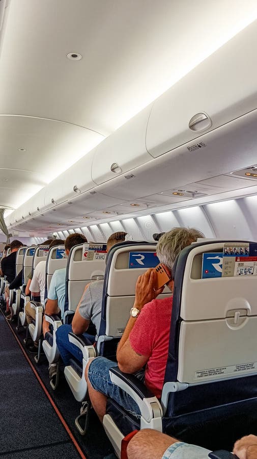 Rows of Seats with Passengers in the Airplane Cabin Editorial Stock ...