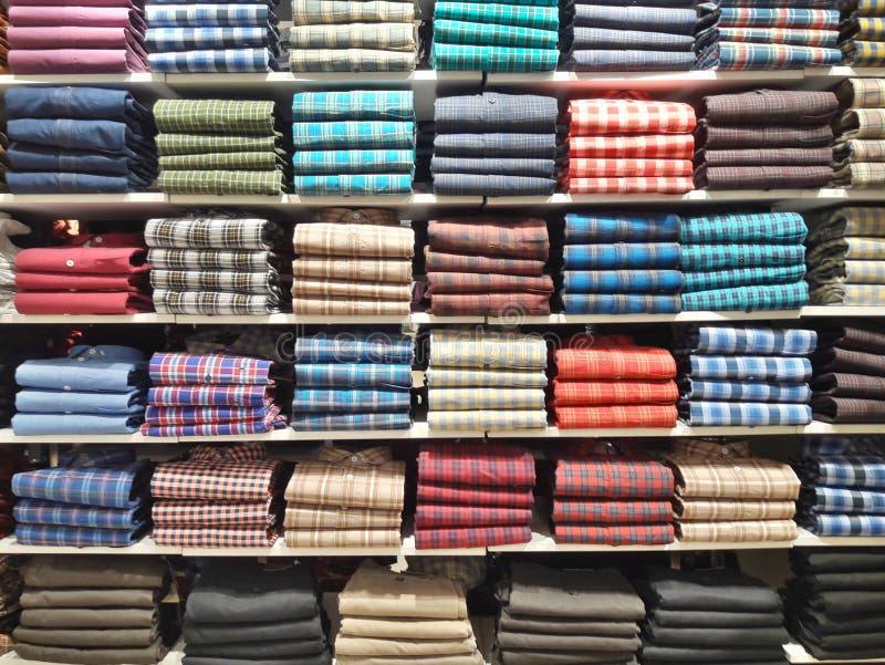 Rows of Shirts Stacked on Parallel Shelves in a Retail Store Stock ...