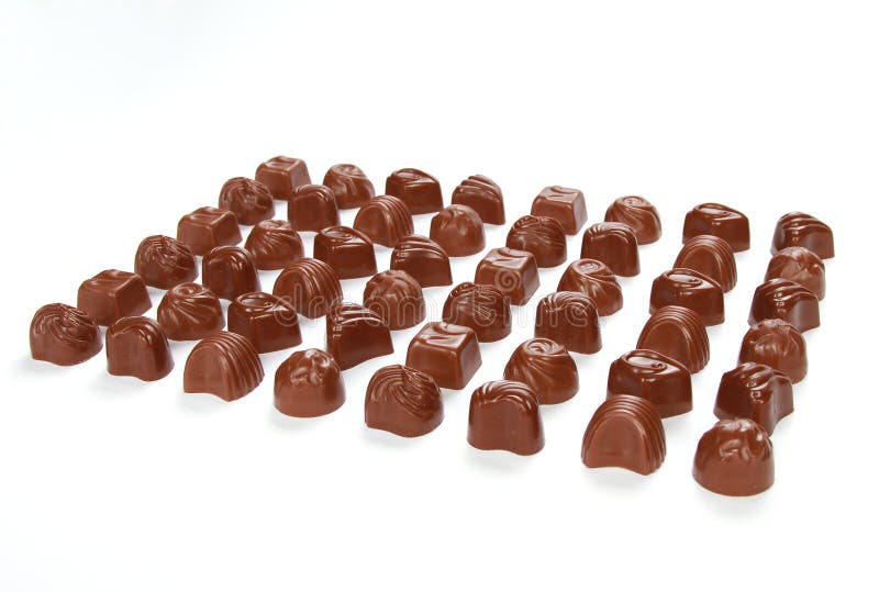 Rows of Small Decorative Chocolates on a White Surface Stock Photo ...