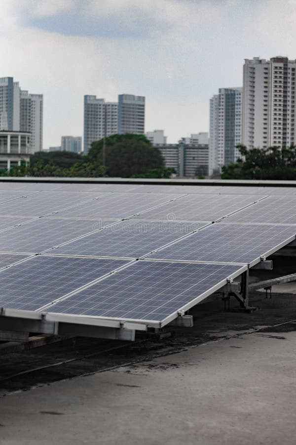 Rows of the Solar Panels Against the High Rise Buildings in a City ...