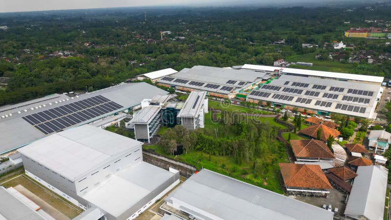 Rows of Solar Panels Installed on the Rooftop of a Factory, Capturing ...