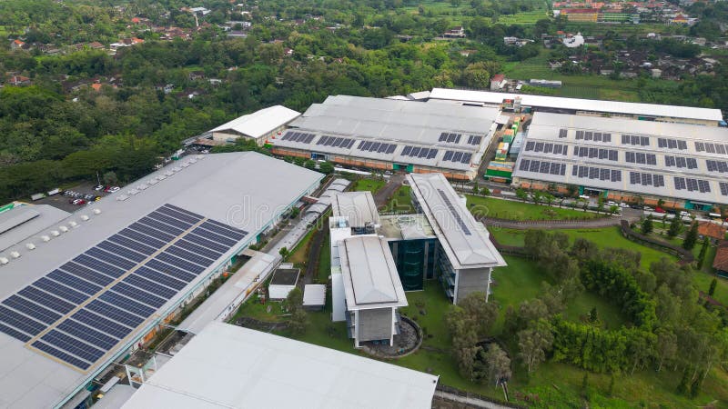 Rows of Solar Panels Installed on the Rooftop of a Factory, Capturing ...