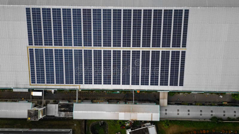 Rows of Solar Panels Installed on the Rooftop of a Factory, Capturing ...