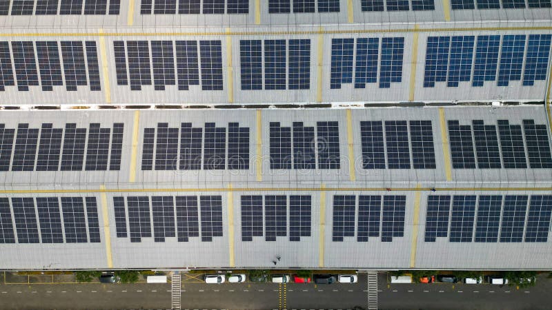 Rows of Solar Panels Installed on the Rooftop of a Factory, Capturing ...