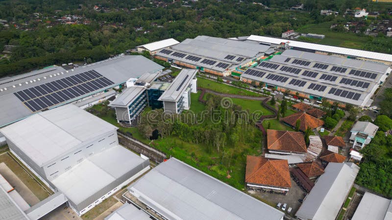 Rows of Solar Panels Installed on the Rooftop of a Factory, Capturing ...