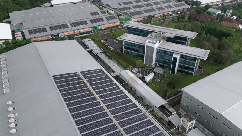 Rows of Solar Panels Installed on the Rooftop of a Factory, Capturing ...
