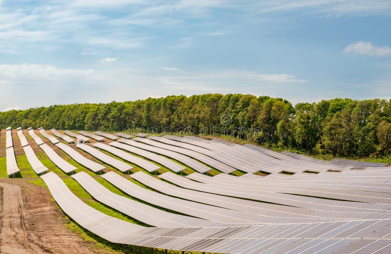 Rows of Solar Panels on the Steep Hills of the Field Stock Image ...