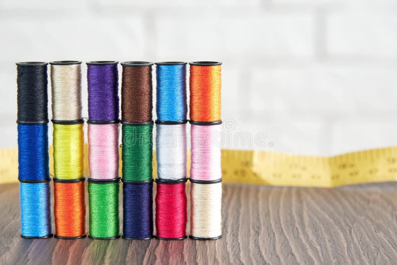 Rows of Spools of Colorful Sewing Threads and Measuring Tape on the ...