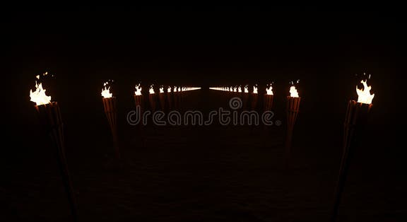 Rows of Torches with Flickering Flames Create a Pathway in a Dark ...