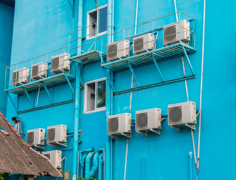 Rows of White Conditioners on the Turquoise Wall, Outdoor. Industrial ...