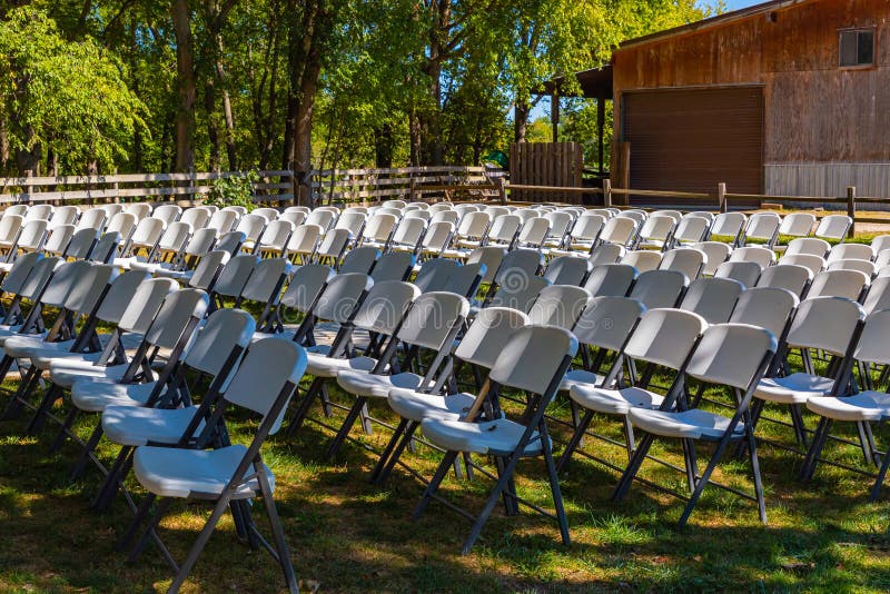 Rows of White Plastic Chairs in the Shade at an Open Air Event Center ...