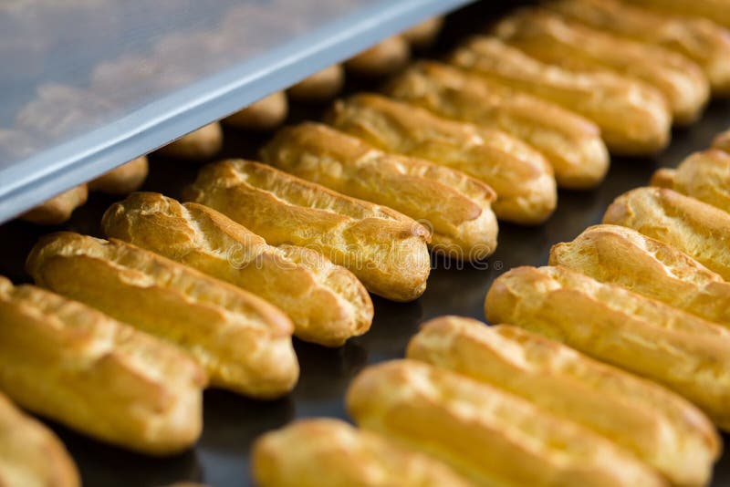 Rows of Yellow Eclair Shells. Stock Image - Image of process, flour ...