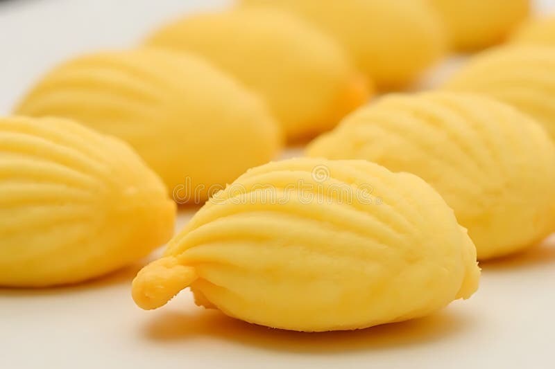 Rows of Yellow Shell Shaped Cookies Presented Nicely on a Plain Surface ...