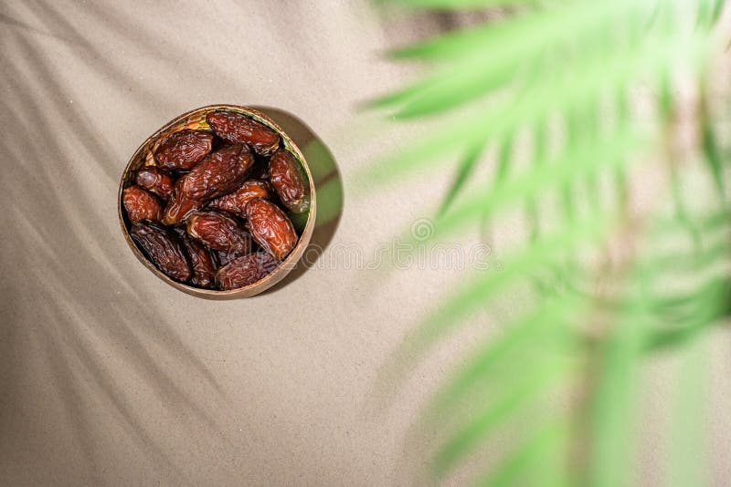 Royal Dates Fruit in a Bowl of Coconut on the Sand Beach Under Palm ...