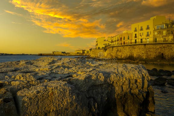 Captivating Sunset Over Rocky Coastline in Italy with Historic ...