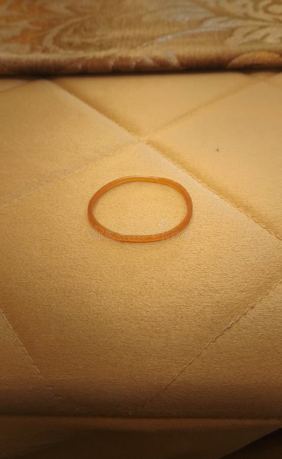 The Rubber Band on the Table is Laid Out in a Golden Color Stock Photo ...