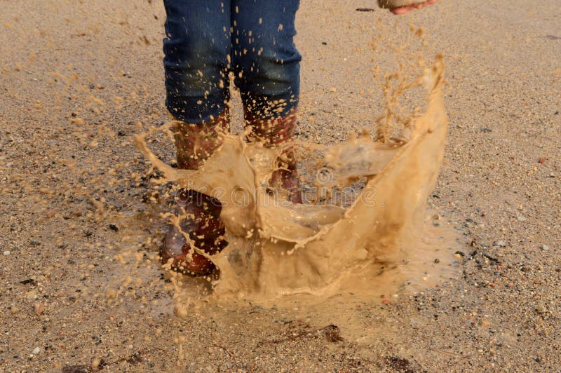 Rubber Boots Splashing Puddle Stock Photo - Image of playful, play ...