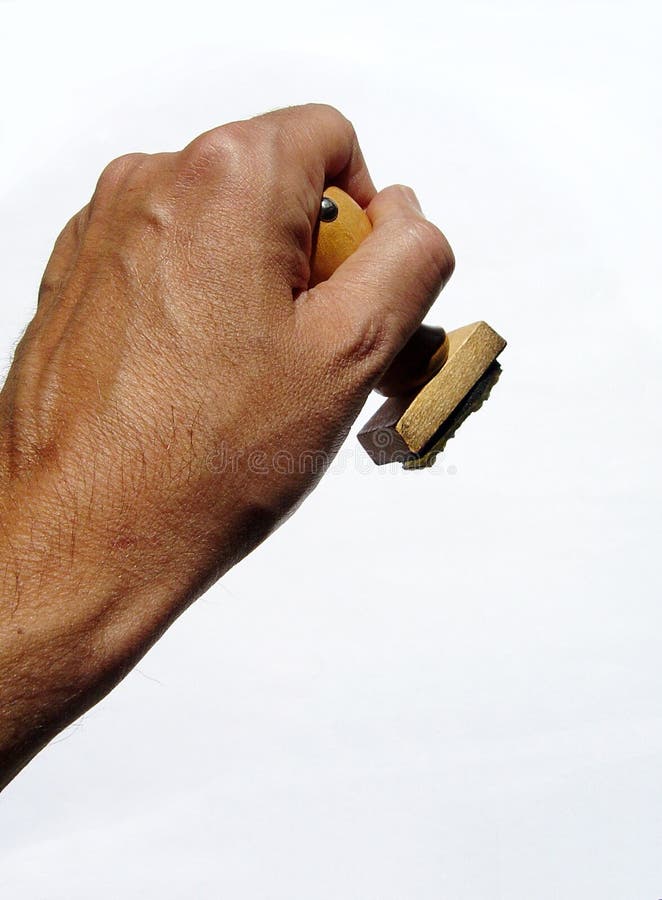 Rubber stamp in hand stock photo. Image of censored, guarantee - 9747914