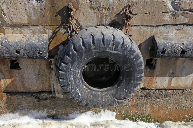 Rubber Tire Fixed on the Shore Stock Photo - Image of buffer ...