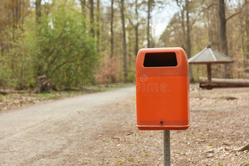 Rubbish Bin or Wastebasket Stands Orange at the Edge of the Path Stock ...