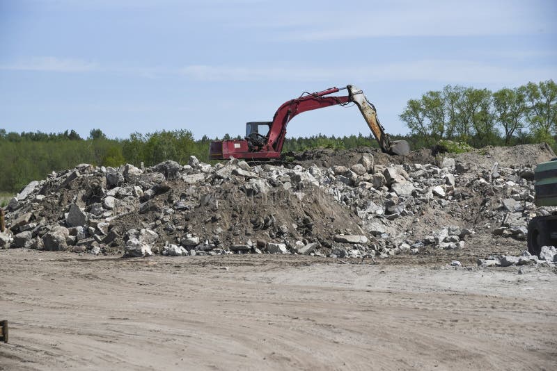 A Rubble Dump with an Excavator Cleaning Up the Mess Stock Image ...