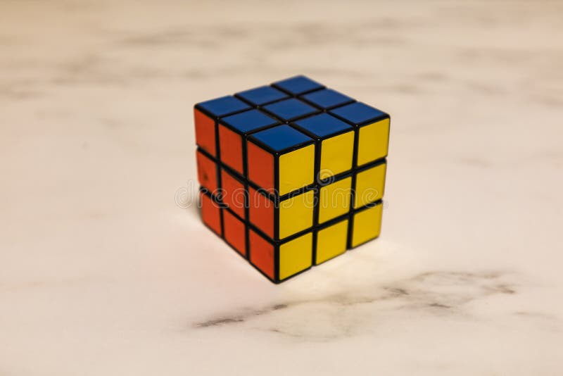 Rubik`s Cube on a Marble Plate, Showing Blue, Yellow and Red Editorial ...