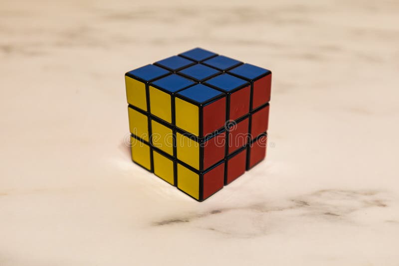 Rubik`s Cube on a Marble Plate, Showing Blue, Yellow and Red Editorial ...