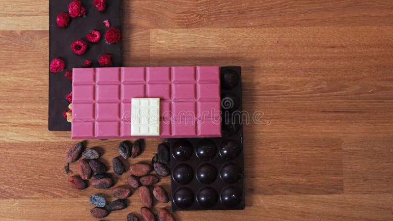 Ruby Dark and White Chocolate Bars on a Wooden Table with Cocoa Seeds ...