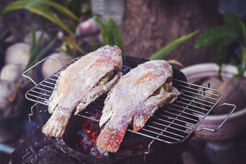 The Ruby Fish is Coated with Salt and Placed on a Charcoal Grill in a ...