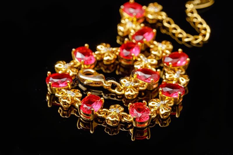Ruby and Gold Necklace on Black Cell Phone Surface Stock Image - Image ...