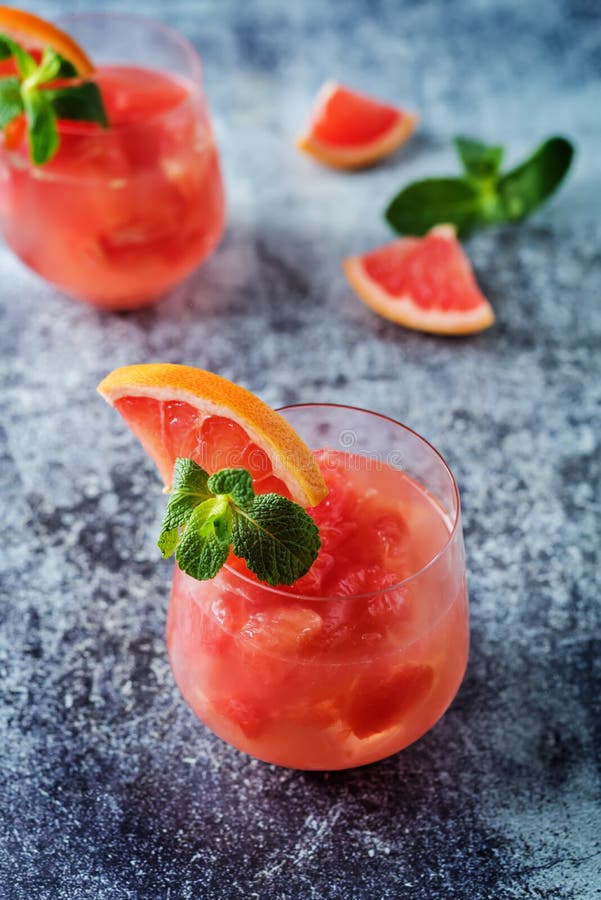 Ruby Red Grapefruit Cocktail with Mint Leaves in Glasses Stock Image - Image of dark, leaves ...