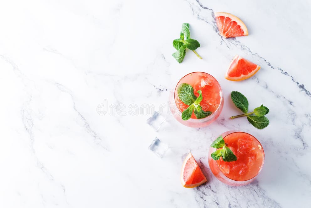 Ruby Red Grapefruit Cocktail with Mint Leaves in Glasses Stock Image ...