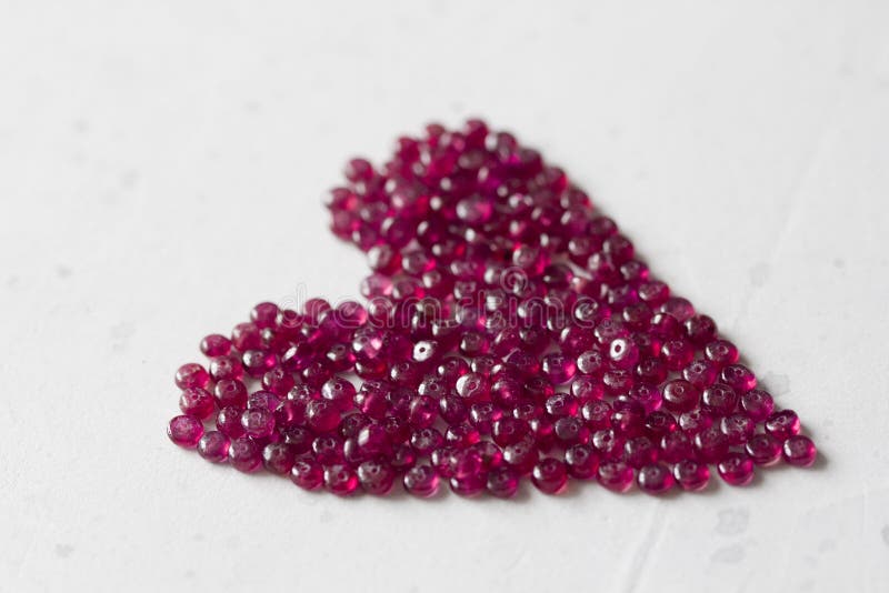 Ruby Stones Lie on a White Table in the Shape of a Heart. Natural ...