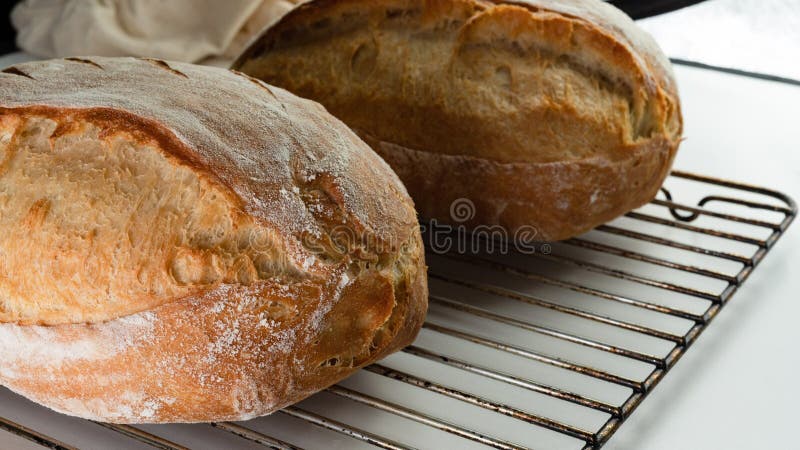 Rustic bread on metal rack stock image. Image of kitchen - 278828397