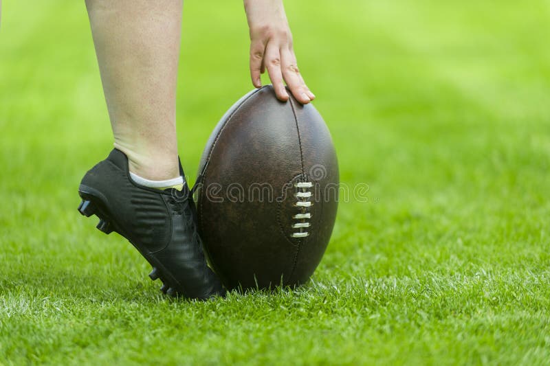 Rugby Ball with His Feet on the Grass Field Stock Image - Image of ...