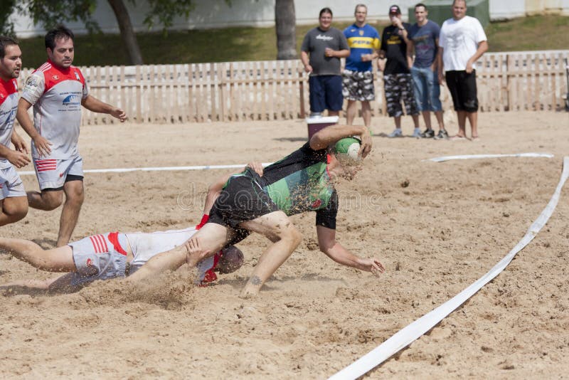 Rugby beach tackle editorial stock image. Image of touchdown - 23099384