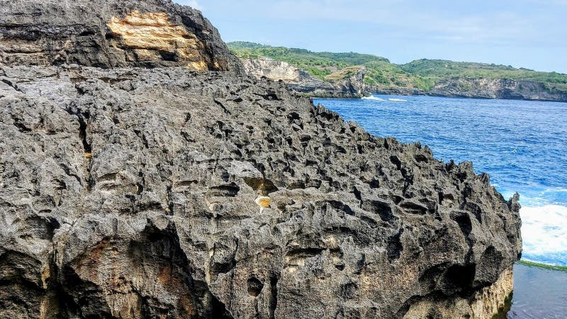 Rugged Cliffs and Jagged Rock Formations Meet the Deep Blue Ocean ...