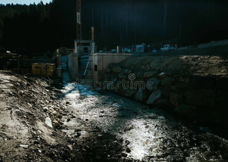 Rugged Construction Site with Flowing Stream and Heavy Equipment in ...