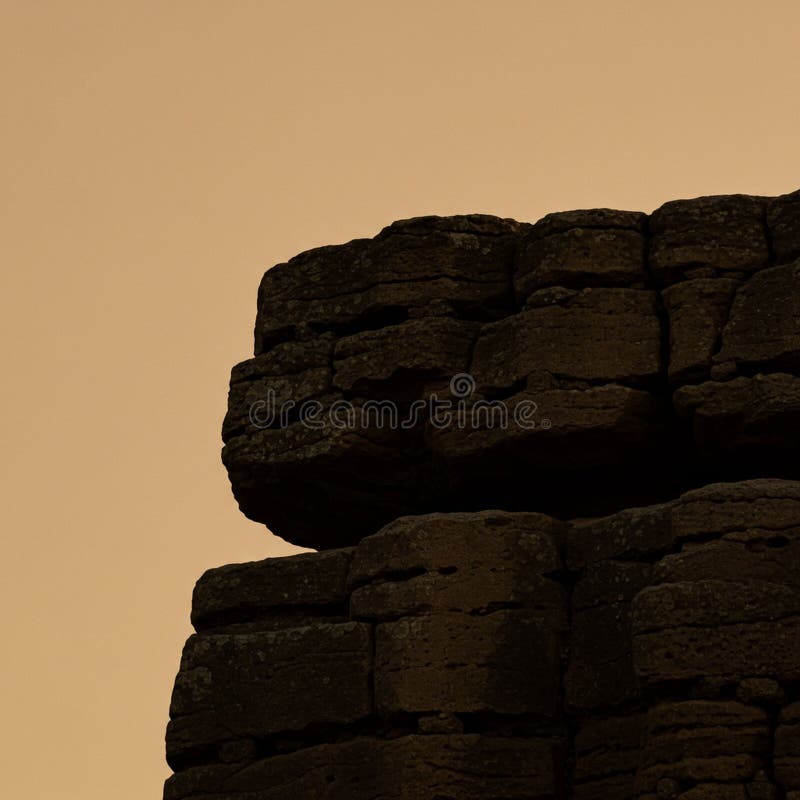 Rugged Dark Stone Structure with Rough, Irregular Surfaces Appears ...